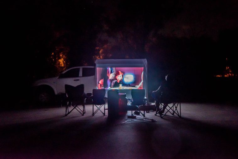 Create an amazing moonlight cinema experience with a portable projector